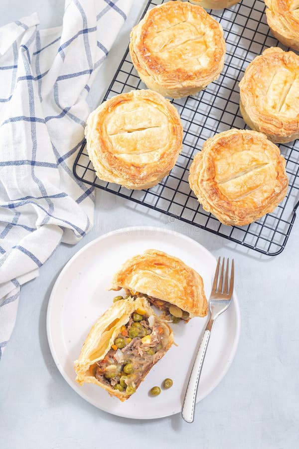 Sliced Beef Pot Pie on Plate, Pies on Cooling Rack, Vertical, Top View ...