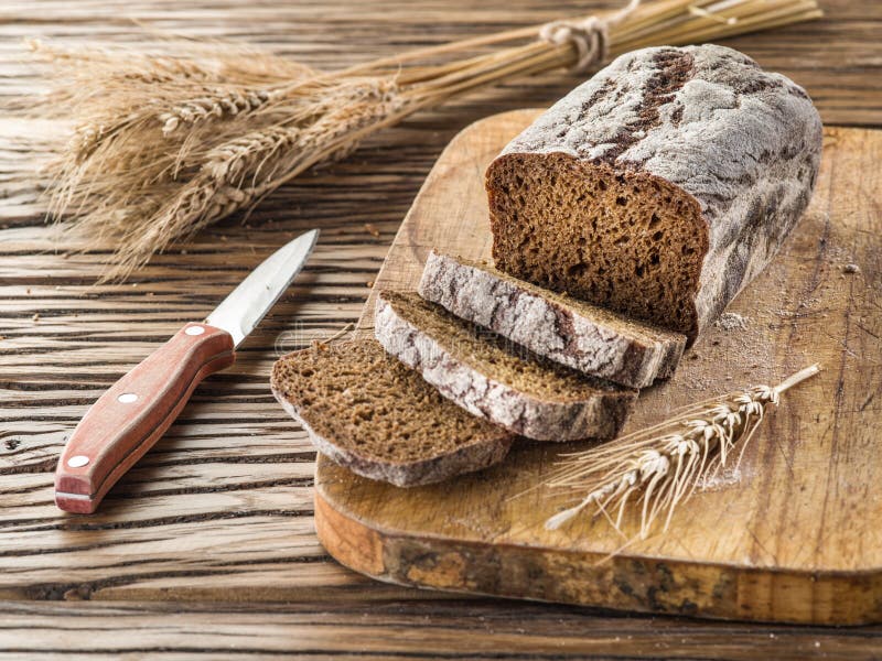Sliced Black Bread on the Wooden Plank. Stock Photo - Image of bread ...