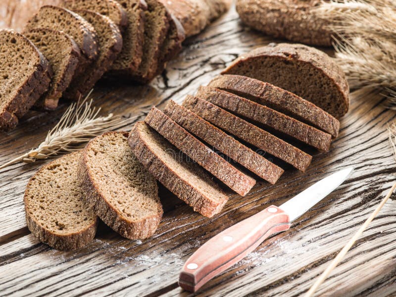 Sliced Black Bread on the Wooden Plank. Stock Photo - Image of golden ...