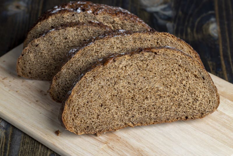 Sliced Black Rye Bread on a Board Stock Photo - Image of black, bakery ...