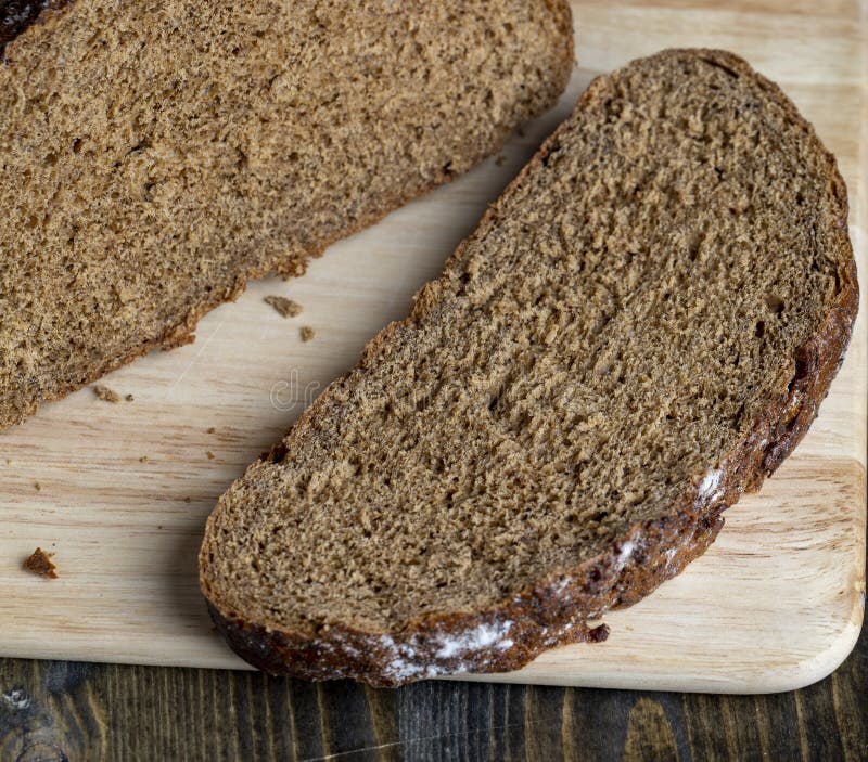 Sliced Black Rye Bread on a Board Stock Photo - Image of wood, loaf ...