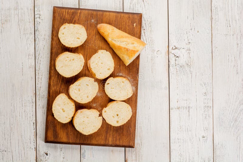 Sliced Bread on Kitchen Board Over Rustic Table. View from Above with ...
