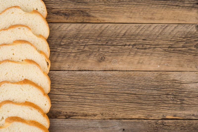 Sliced Bread on an Old Wooden Table. Stock Image - Image of oval, brown ...