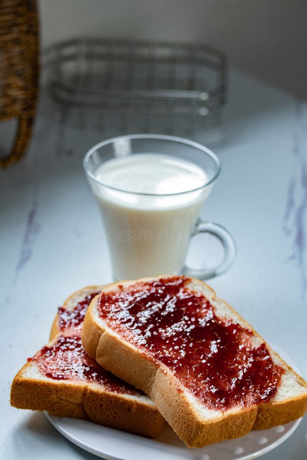 Sliced Bread Spread with Red Raspberry Jam and Fresh Milk Stock Image ...