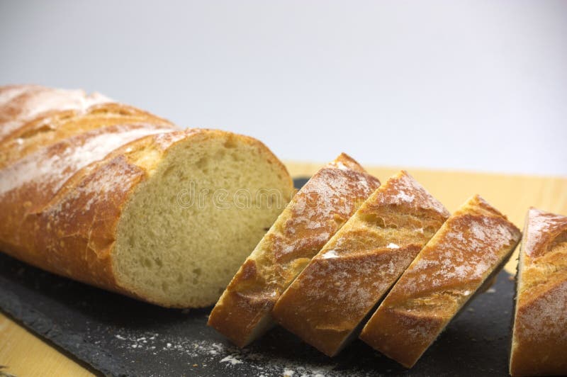 Sliced Bread on a Table Slate Stock Photo - Image of brown, crusty ...