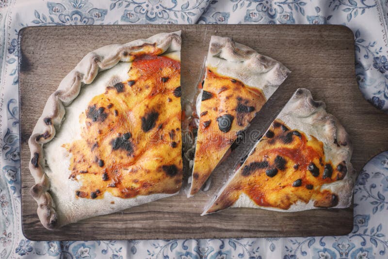 Sliced Calzone on the Wooden Board Top View Stock Photo - Image of ...