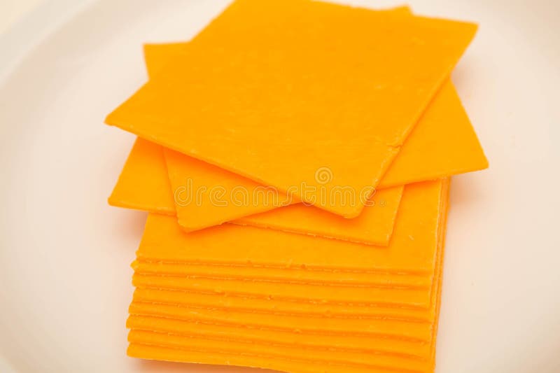 Sliced Cheddar Cheese on White Plate Stock Photo - Image of cheese ...