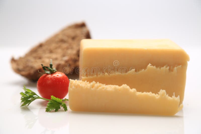 Sliced Cheese with a Cherry Tomato on the Side Stock Image - Image of ...
