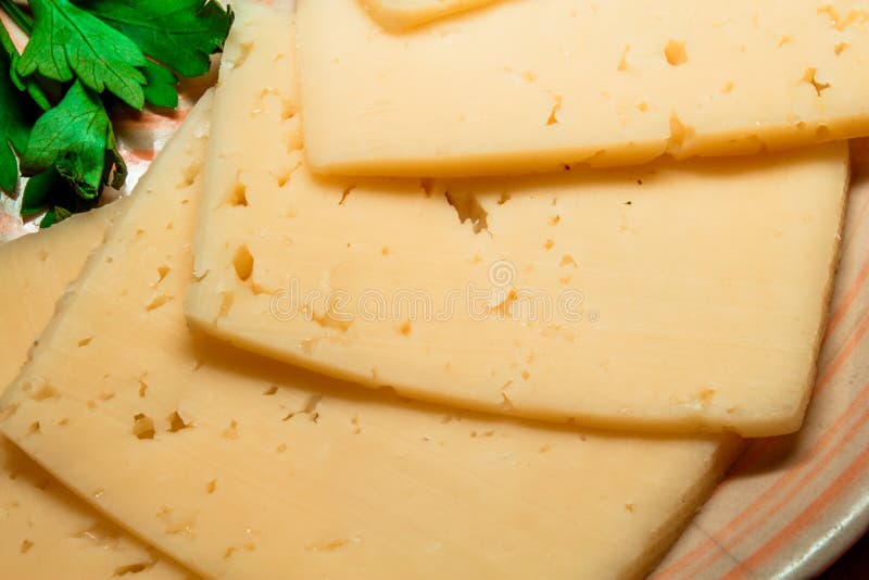 Sliced Cheese Lying on a Plate with Greens Stock Photo - Image of cheez ...