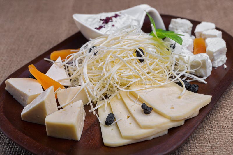 Sliced Cheeses of Different Types on a Dark Board Stock Photo - Image ...