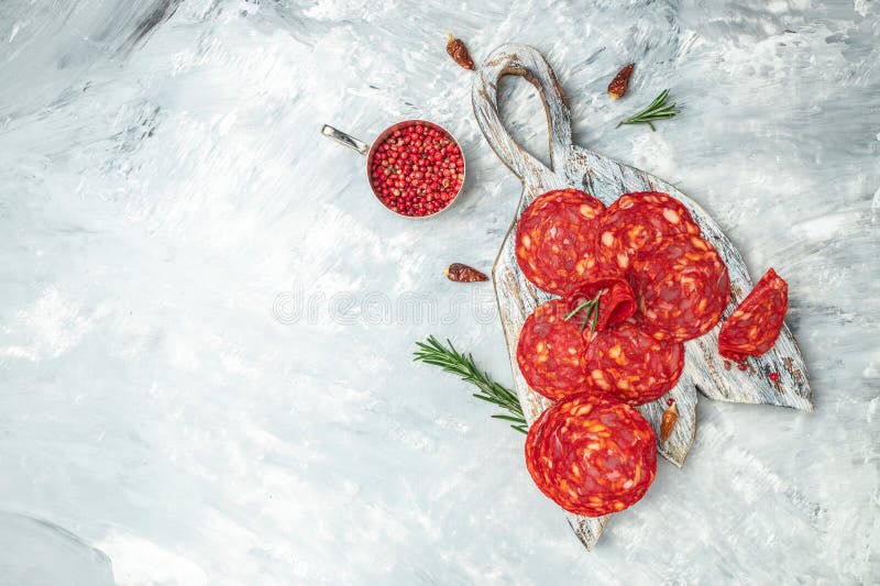 Sliced Chorizo Salami Thin Cut on Plate on a Light Background. Long ...