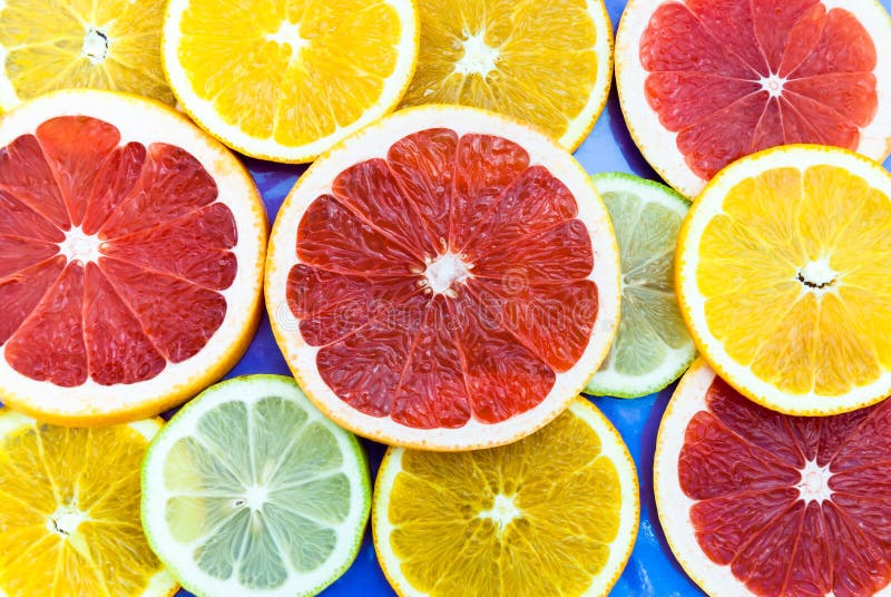 Sliced Citrus on Blue Background Stock Photo - Image of healthy ...