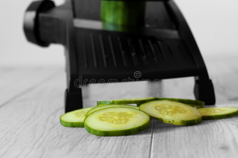 Sliced Cucumber with Mandoline on a Grey Wood Kitchen Worktop Stock ...
