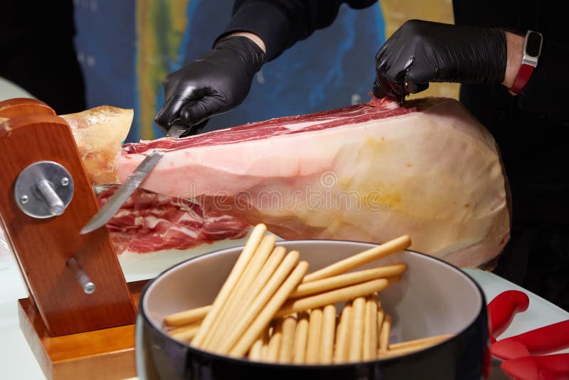 Sliced Dried Chamon Prosciutto. a Man Cuts a Jamon, a Warm Toned Image ...