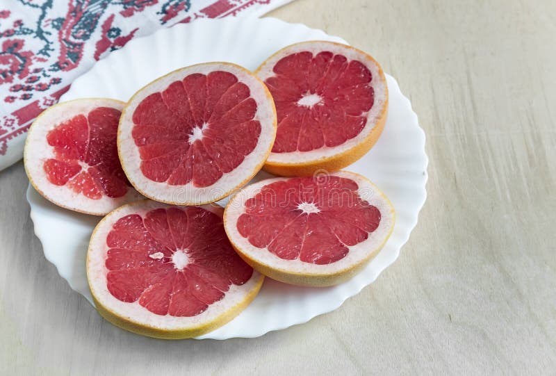 Sliced Fruit of the Grapefruit on the Plate. Stock Photo - Image of ...