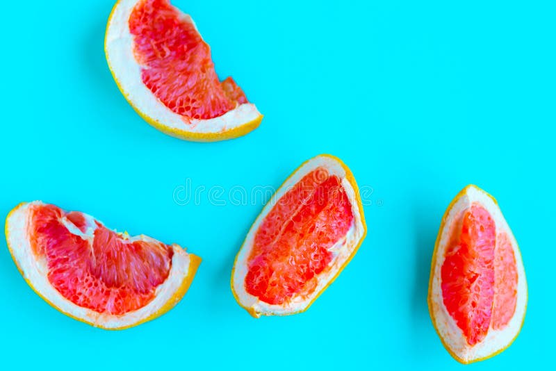 Sliced Grapefruit Pieces on Blue Background Stock Image - Image of blue ...