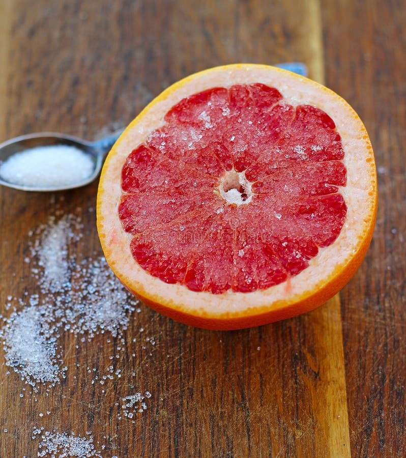 Sliced Grapefruit with Sugar on Wooden Plank Stock Photo - Image of ...