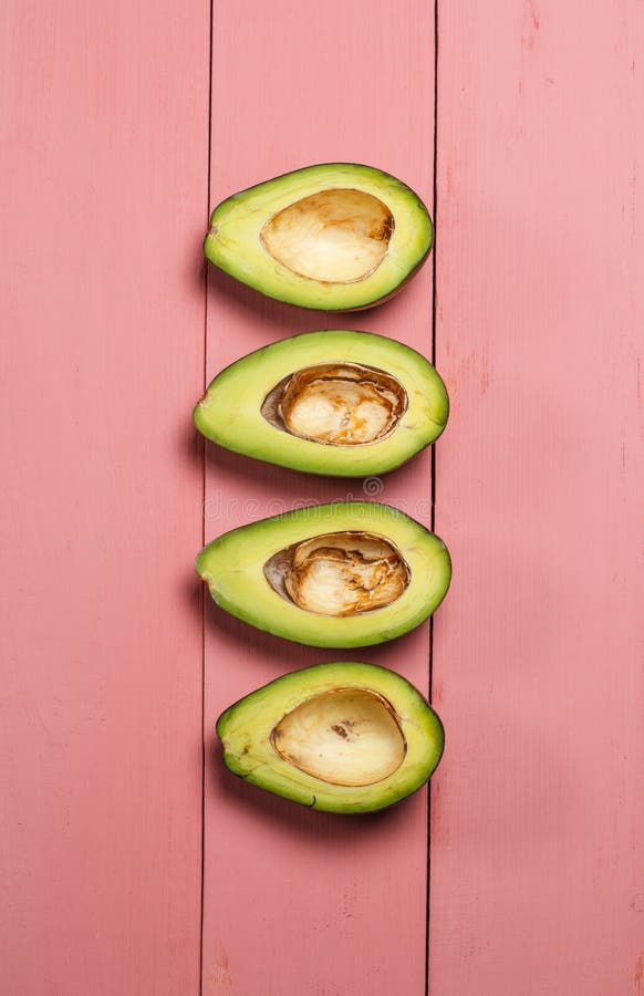 Sliced Green Avocado on a Red Surface Stock Image - Image of eating ...