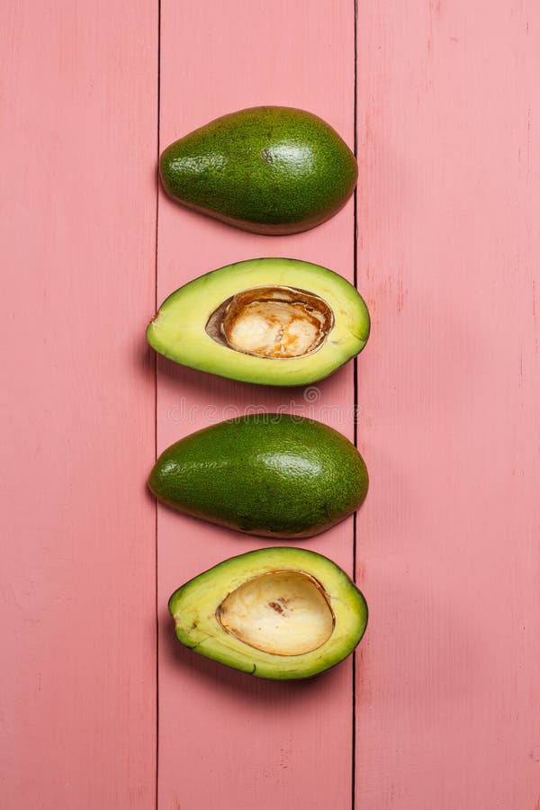 Sliced Green Avocado on a Red Surface Stock Photo - Image of paint ...