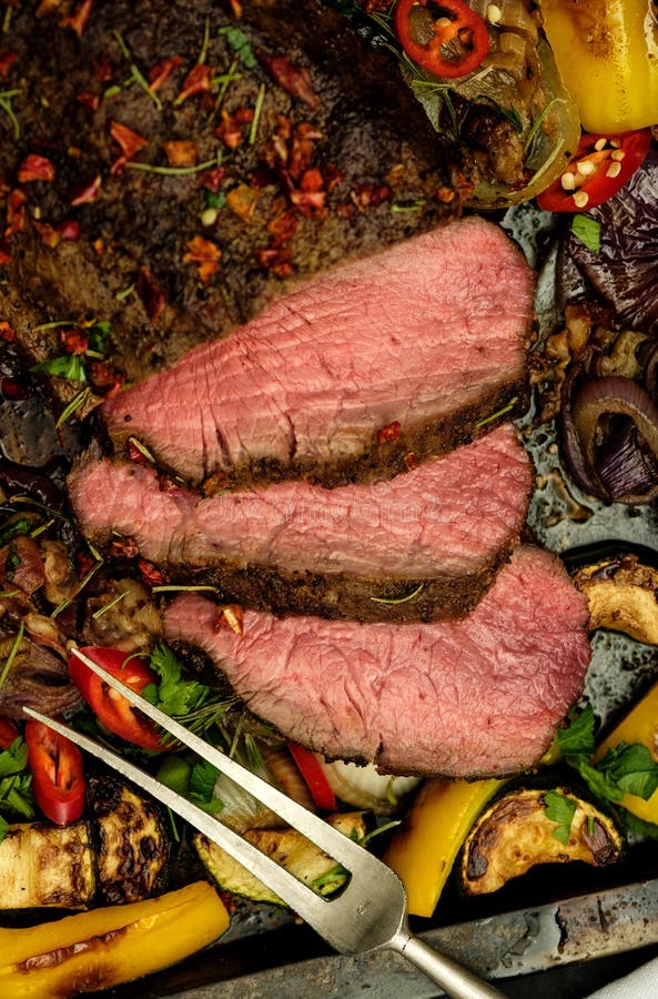 Sliced Grilled Beef Rump Steak on Baking Tray with Vegetables. Stock ...