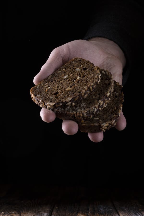 Sliced Homemade Bread in Hand on a Black Background Stock Photo - Image ...