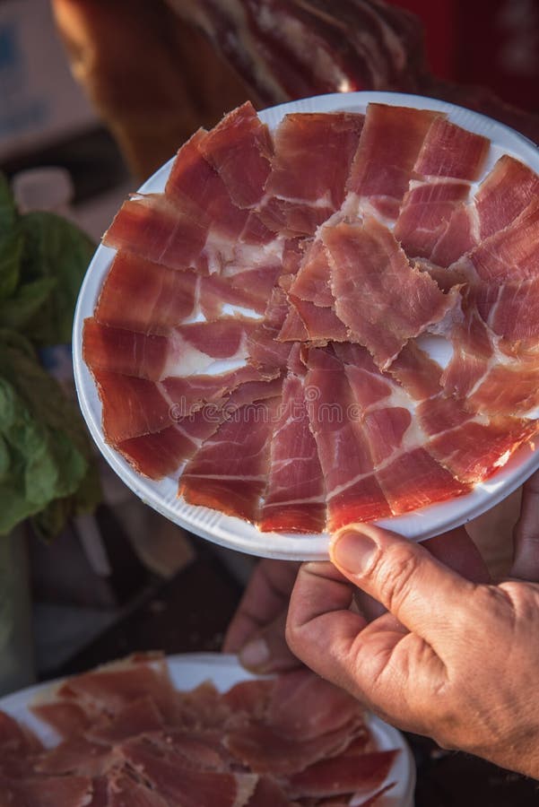 Sliced Jamon Iberico on the Plate with a Hand. Selective Focus.3 Stock ...