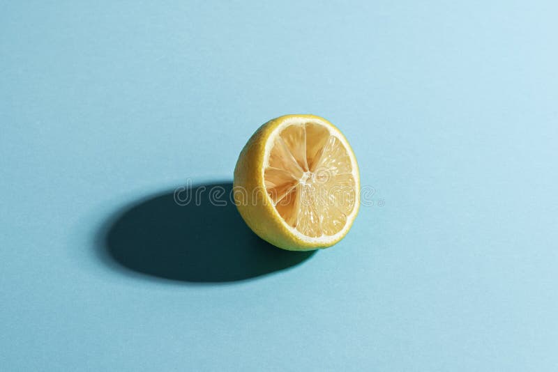 Sliced Lemon on a Blue Background. Conceptual Minimalism Stock Photo ...