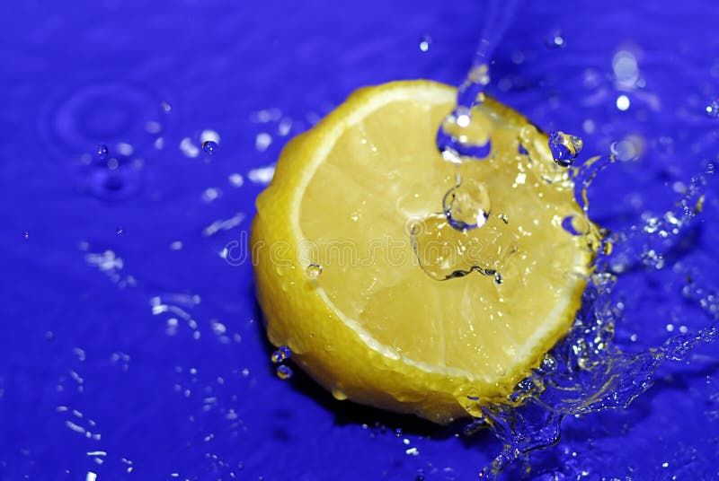 Sliced lemon in blue water stock photo. Image of liquid - 1725846