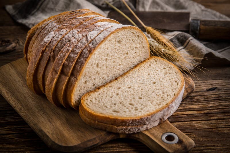 Sliced Loaf of Bread on a Chopping Board. Stock Photo - Image of sliced ...