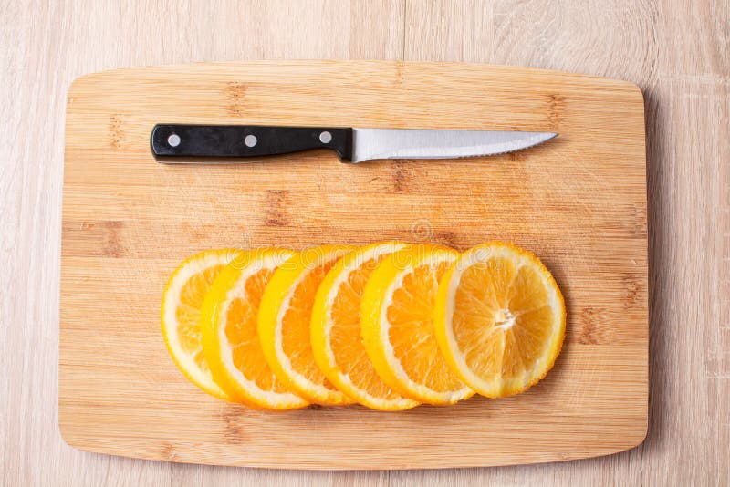 Sliced Mandarin with the Cuuting Knife on the Wooden Cutting Table ...