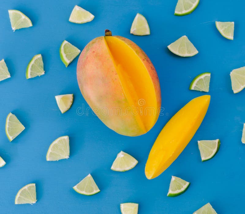 Sliced Mango on Blue Background with Sliced Lemon. Flat Lay Stock Image ...