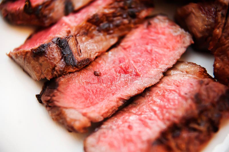 Sliced Medium Rare Steak with Blood on a Plate Close-up. Macro Stock ...
