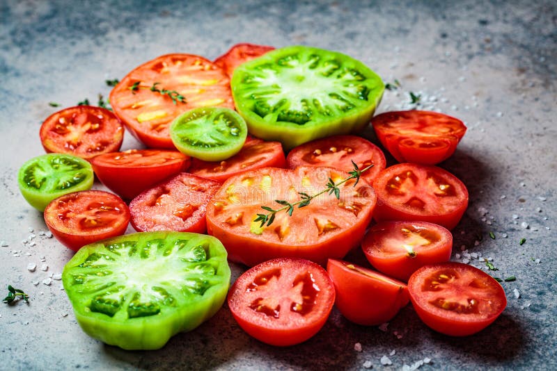 Sliced Multi-colored Ripe Tomatoes on Dark Blue Background, Top View ...