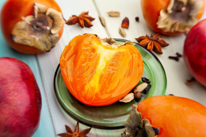 Sliced persimmon on wood stock image. Image of tasty - 267654317