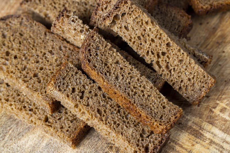 Sliced Piece of Black Rye Bread on a Board Stock Image - Image of wheat ...