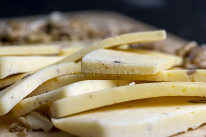 Sliced Piece of Milk Cheese with Walnuts Stock Photo - Image of ...