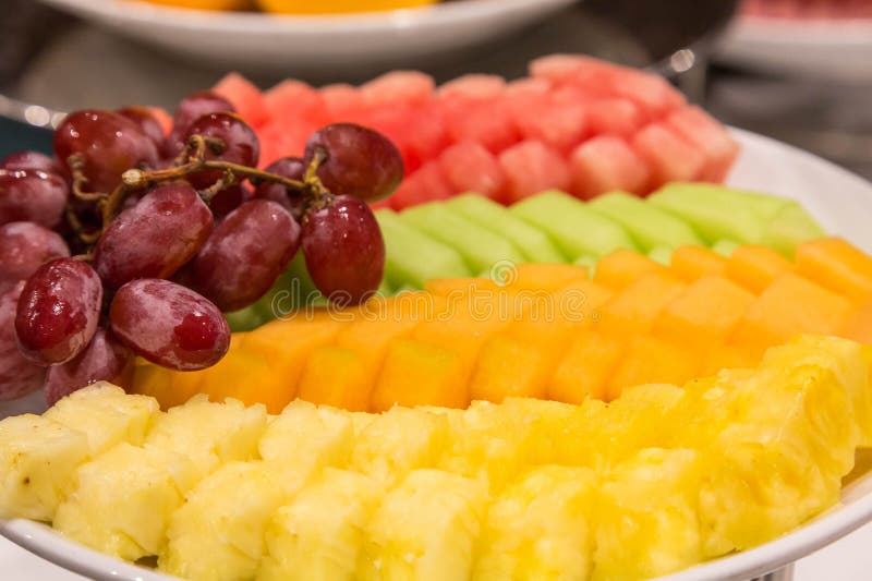 Sliced Pineapple And Melon With Grapes Stock Photo - Image: 49333290