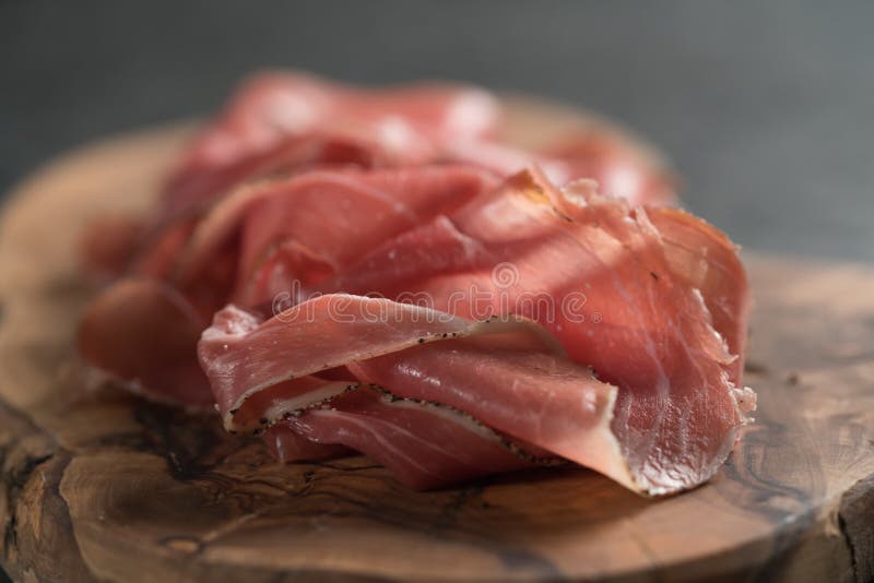 Sliced Prosciutto Ham on Olive Wood Board Stock Image - Image of black ...
