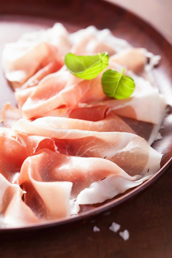 Sliced prosciutto ham stock photo. Image of wood, basil - 43166796