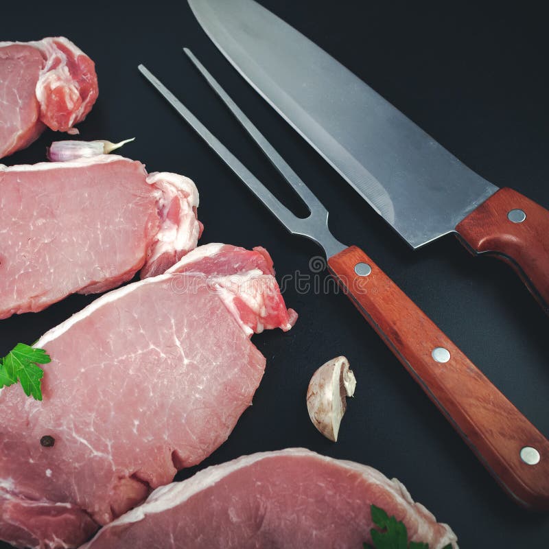 Sliced Raw Pork Meat with Knife and Meat Fork on Dark Background Stock ...