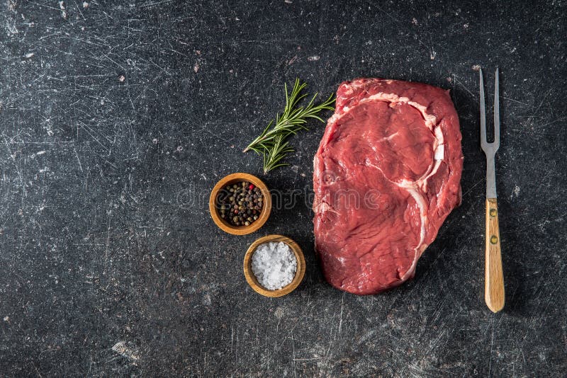 Sliced Raw Ribeye Steak on Black Kitchen Table Stock Image - Image of ...