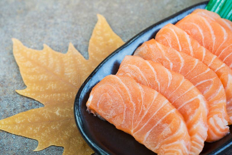 Sliced Raw Salmon on Black Plate Stock Image - Image of fatty, maple ...