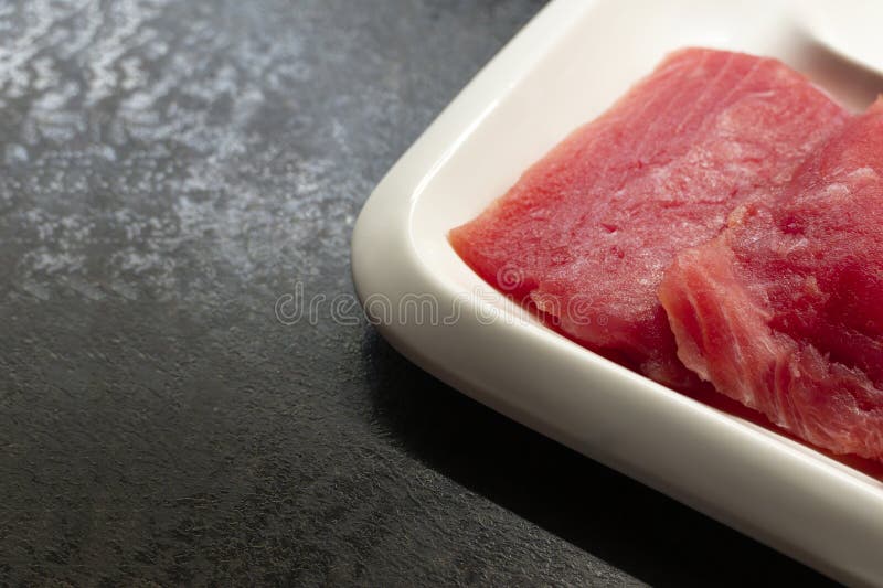 Sliced Raw Tuna Fish on White Rectangular Plate on Black Table Stock ...