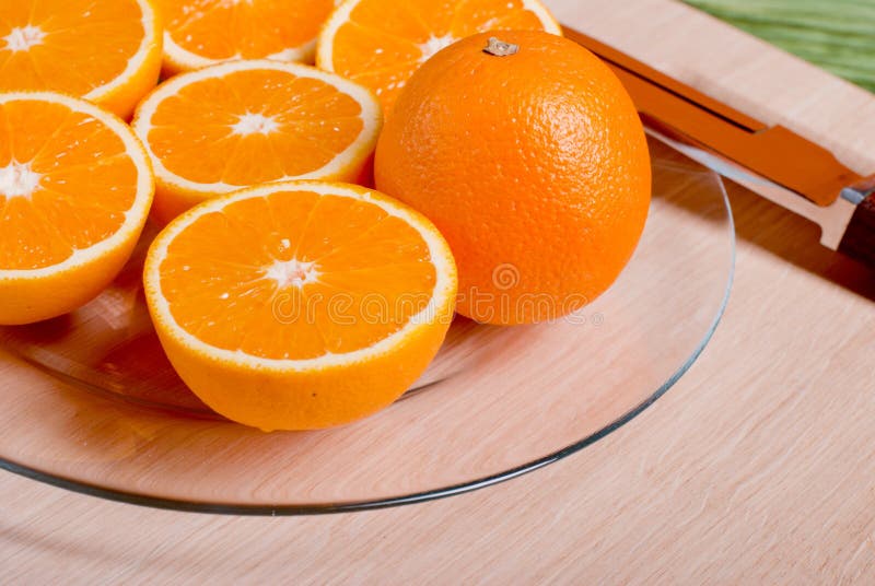 Sliced Ripe Appetizing Orange on a Cutting Board on a Green Table Stock ...