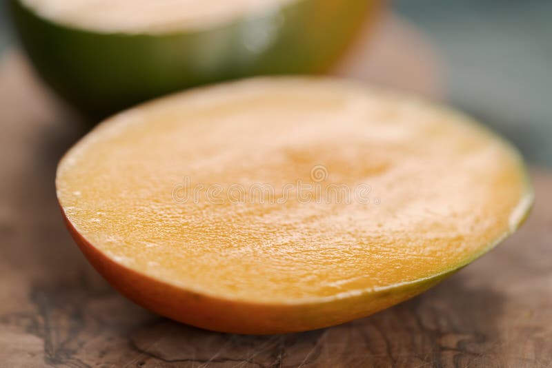 Sliced Ripe Red Mango on Olive Wood Board Stock Image - Image of teal ...