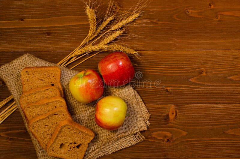 Sliced Rye Bread, Apples and Ears of Corn on Sackcloth, Wooden Table ...
