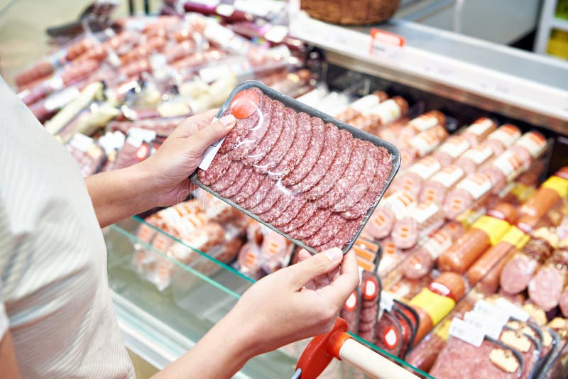 Sliced Sausage in Hands in Store Stock Photo - Image of customer, pink ...