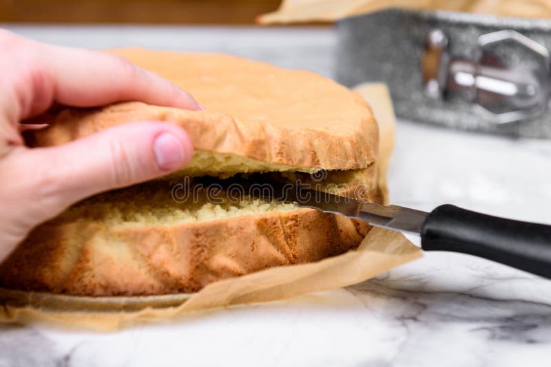Sliced Sponge Cake with Knife for Making Cake on White Table. Stock ...