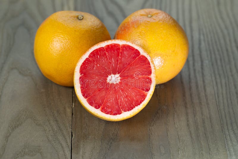 Sliced and Whole Ruby Red Grapefruits Stock Photo - Image of aged ...