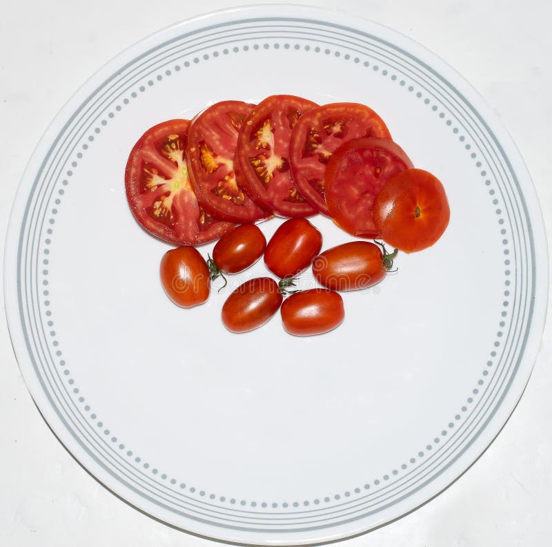 Sliced and Whole Tomatoes on a White Plate. Stock Image - Image of ...
